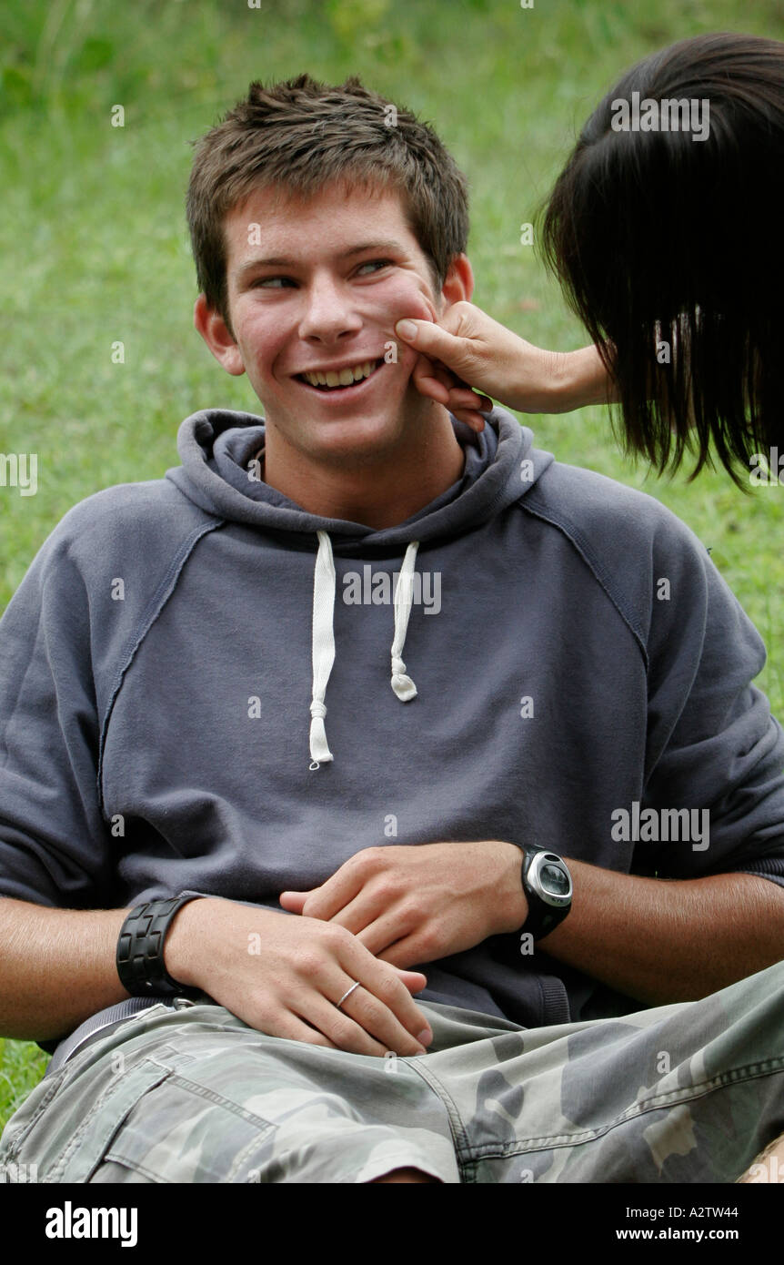 A smiling boy gets his cheek pinched Stock Photo - Alamy