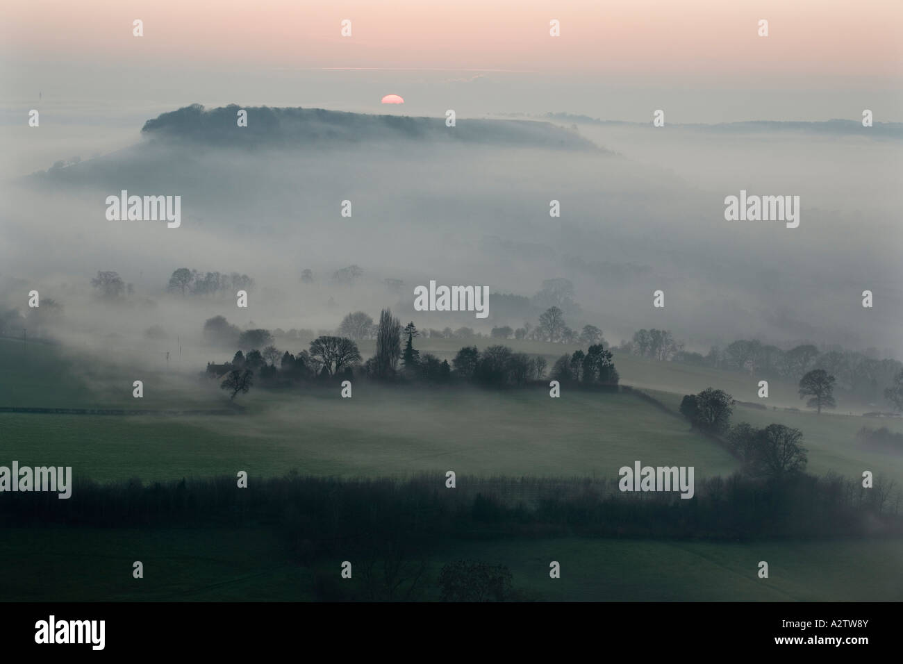 Cam Long Down shrouded in mist from Coaley Peak on the Cotswold Way ...