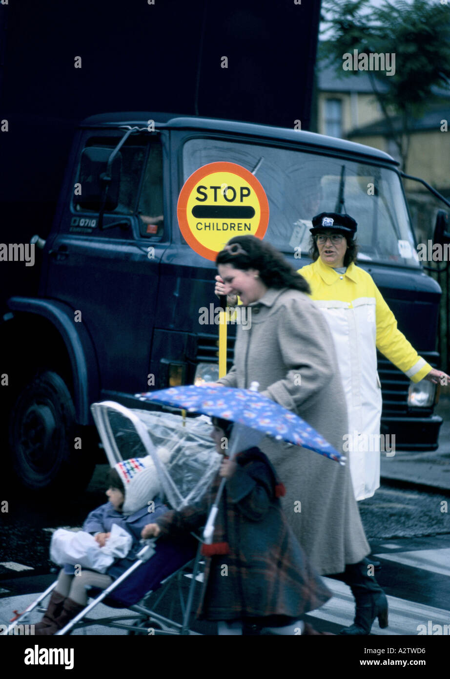lollipop lady at zebra crossing Stock Photo - Alamy