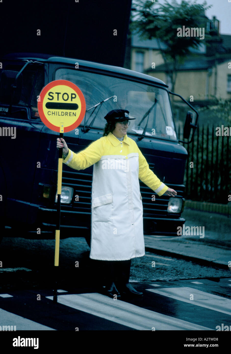 lollipop lady at zebra crossing Stock Photo - Alamy