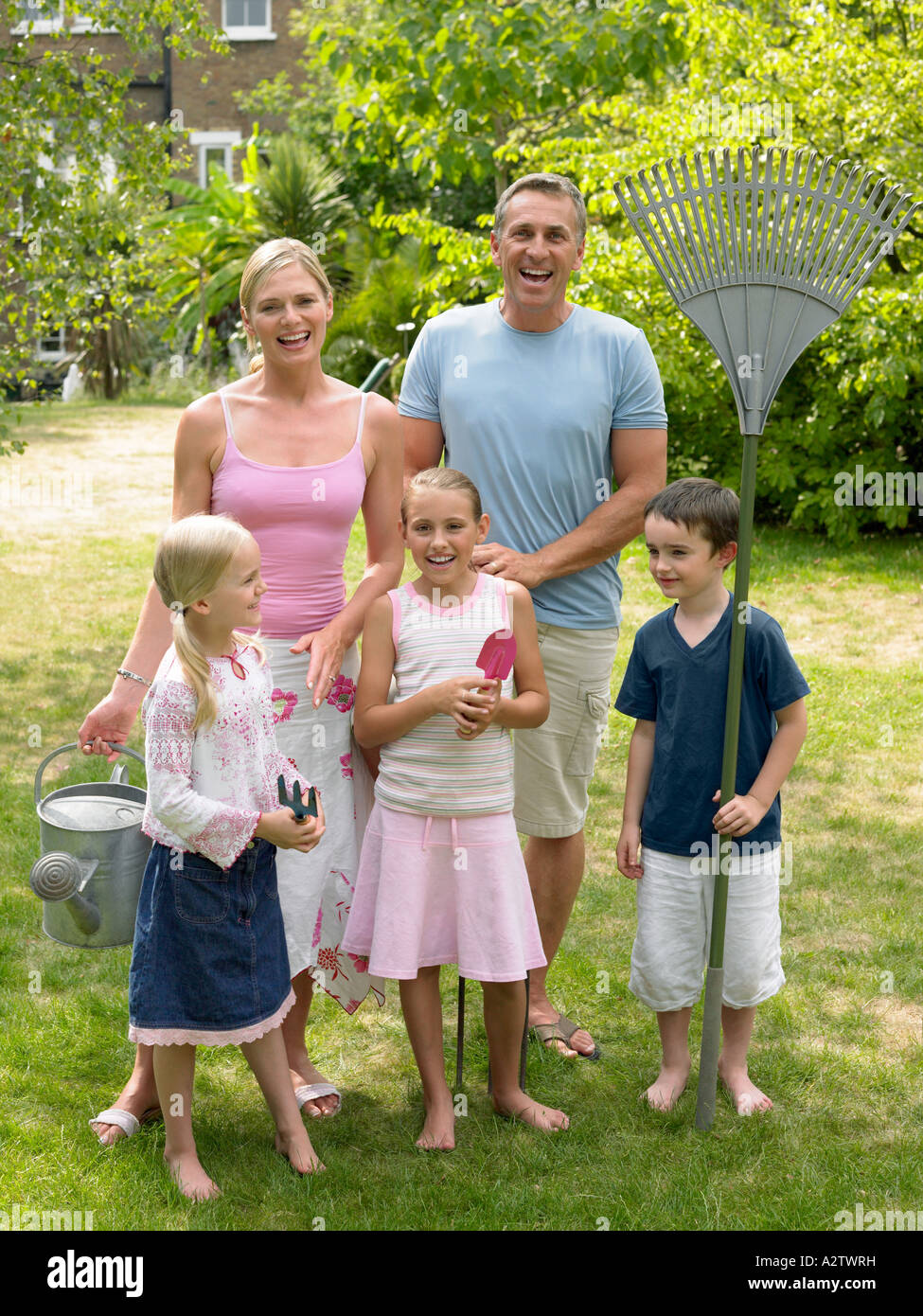 Family standing in garden Stock Photo - Alamy