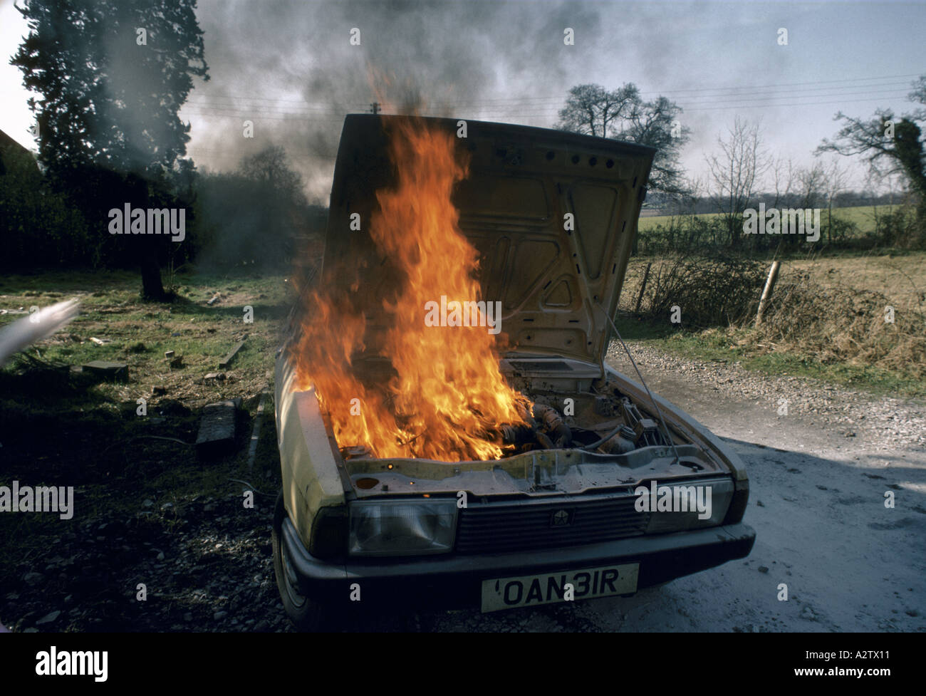 chrysler car bonnet lifted up half of what is underneath is on fire ...