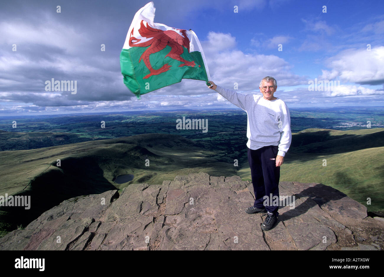 Man with Welsh flag on the summit of Pen-y-Fan, Brecon Beacons National ...
