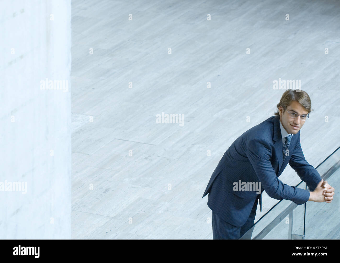 Businessman leaning against handrail hi-res stock photography and ...