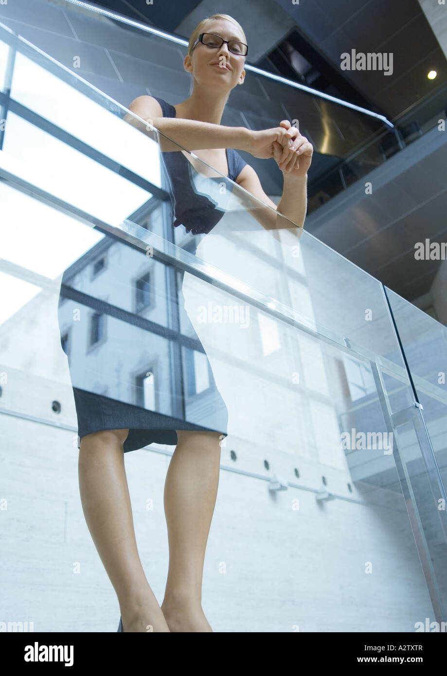 Businesswoman leaning against guard rail hi-res stock photography and ...
