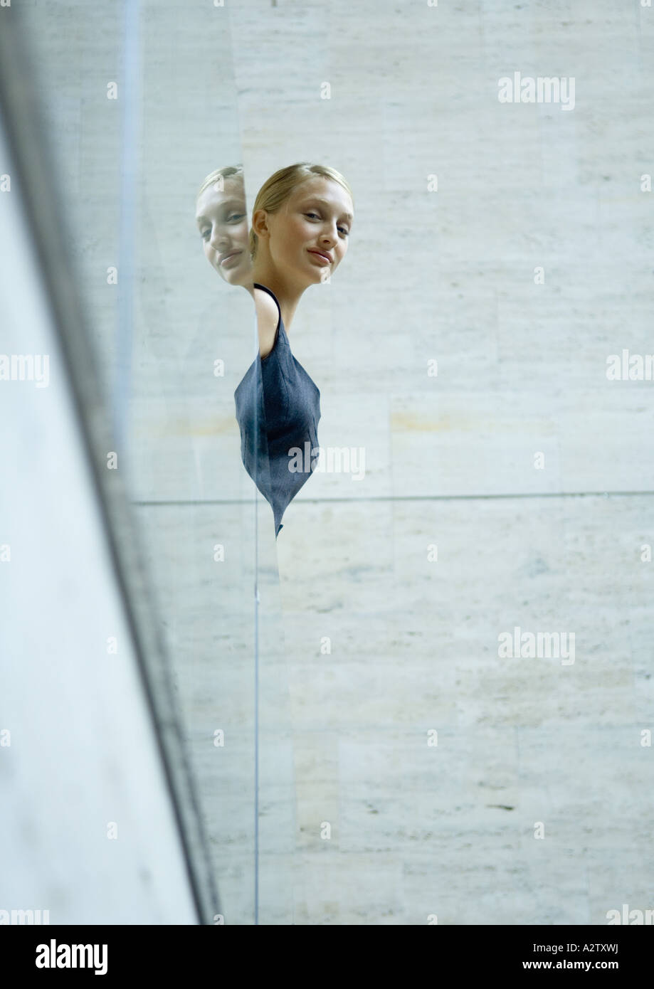 Woman looking over glass guard rail, low angle view Stock Photo - Alamy
