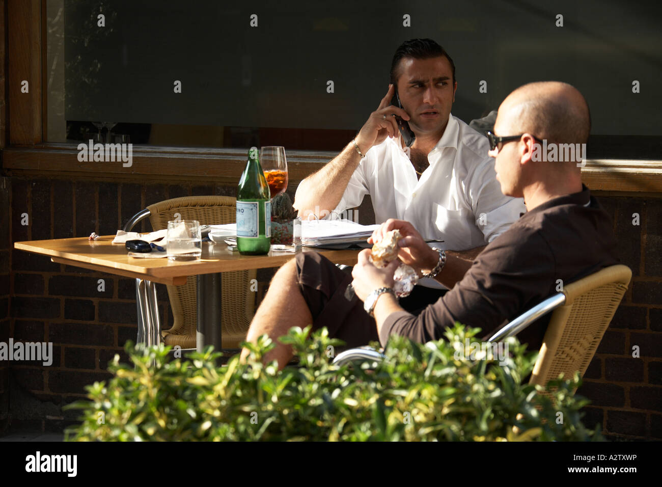 Two men at a cafe table in Mayfair London W1 England Stock Photo - Alamy