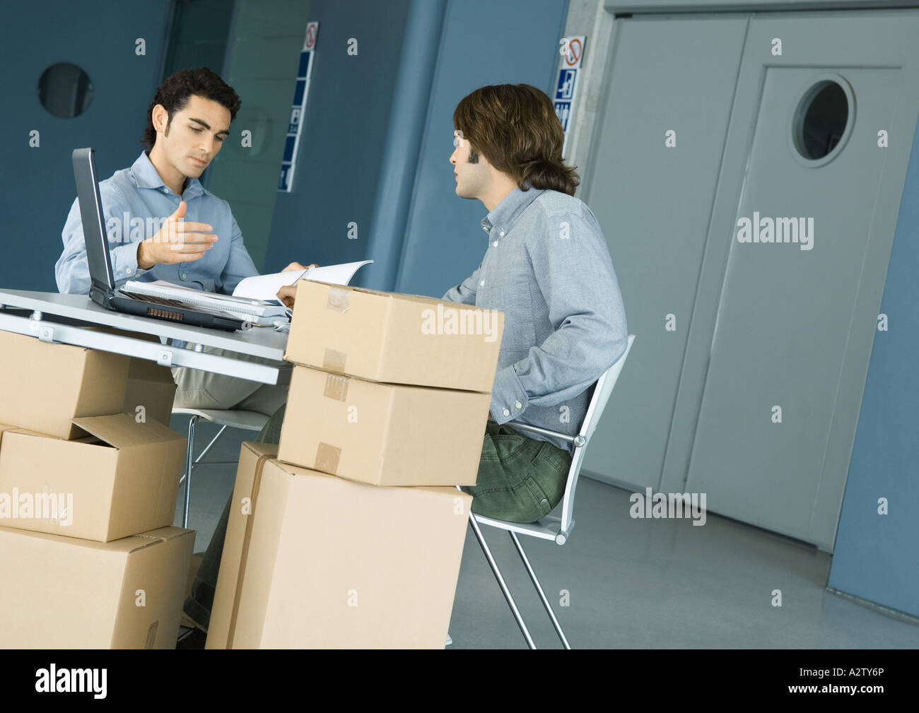Two men sitting across the desk hi-res stock photography and images - Alamy