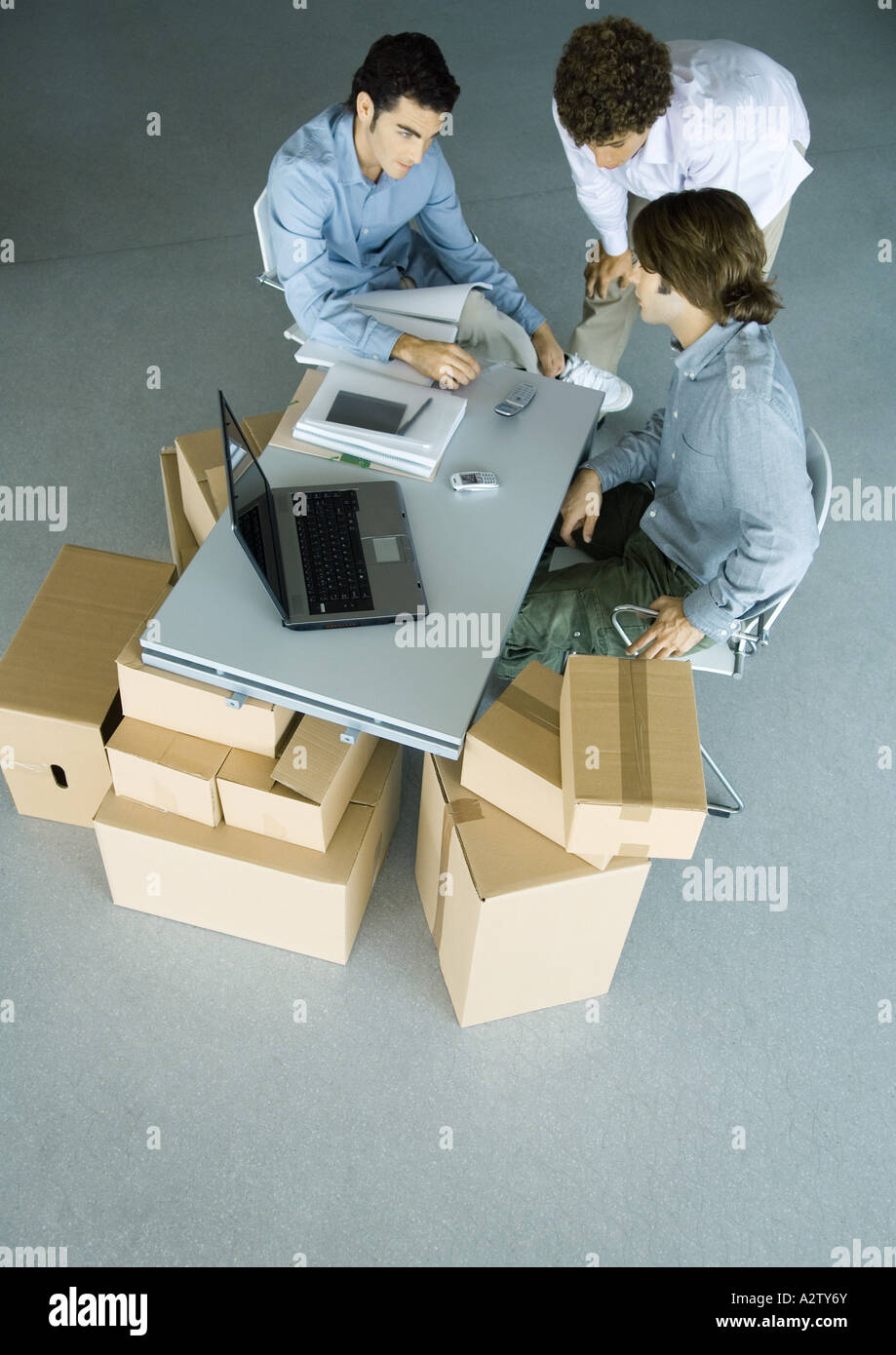 Business people grouped around laptop hi-res stock photography and ...
