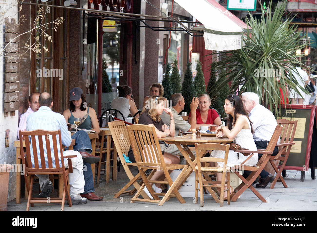 People eating and drinking at outdoor cafe restaurant in Mayfair London ...