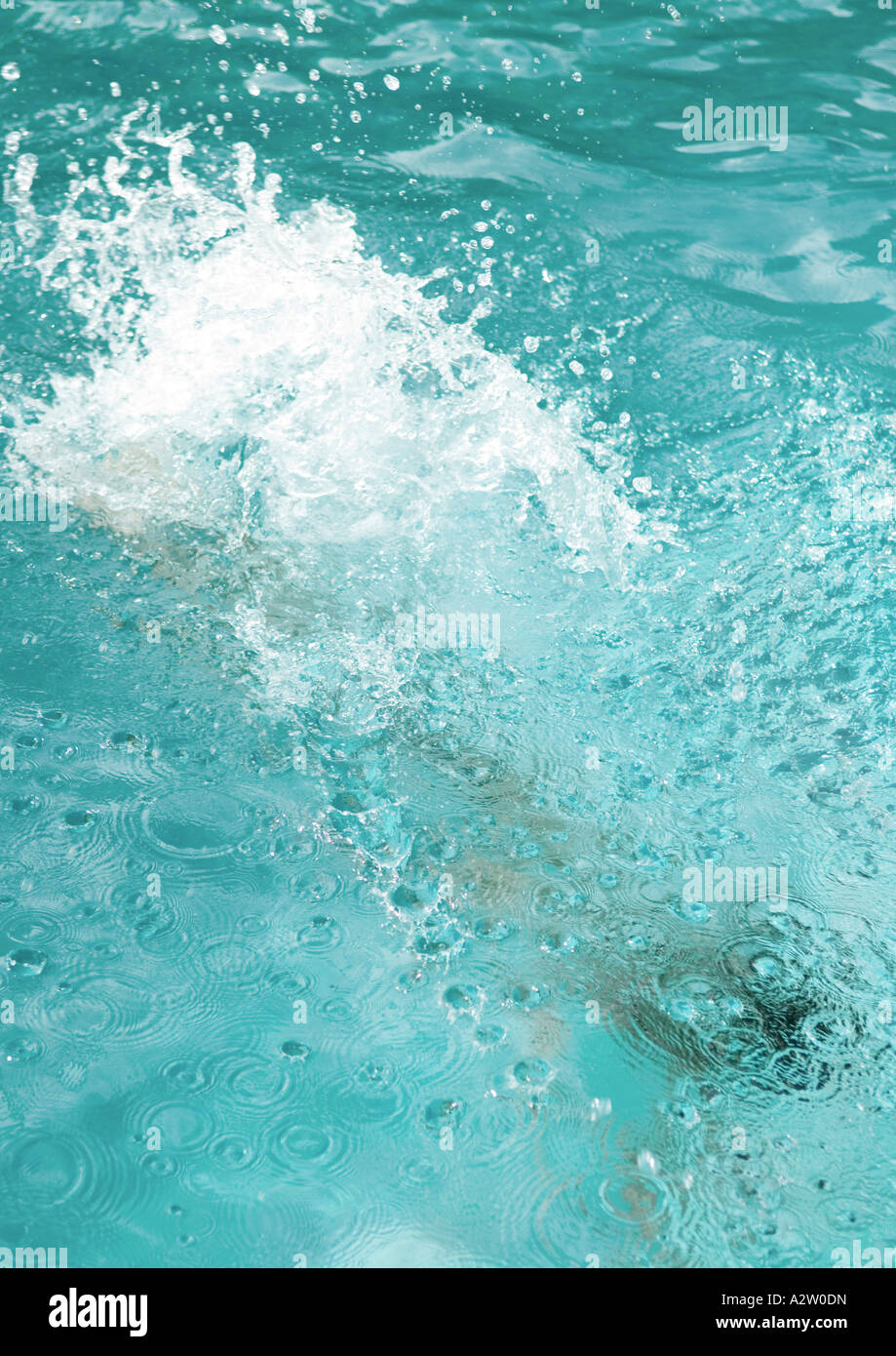 Surface of swimming pool splashing as swimmer moves underneath Stock ...