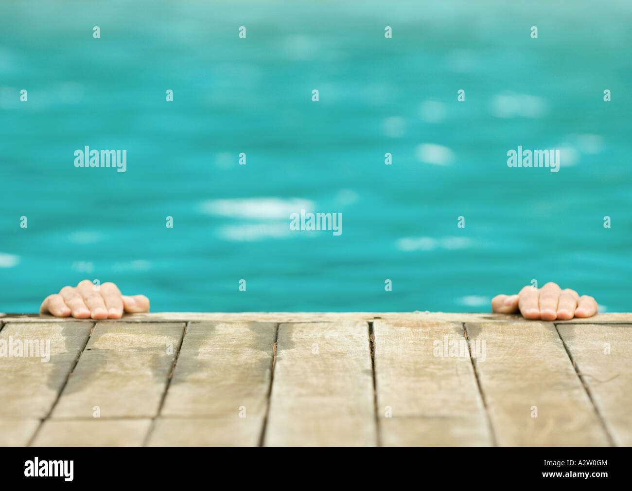 Hands on edge of pool Stock Photo - Alamy