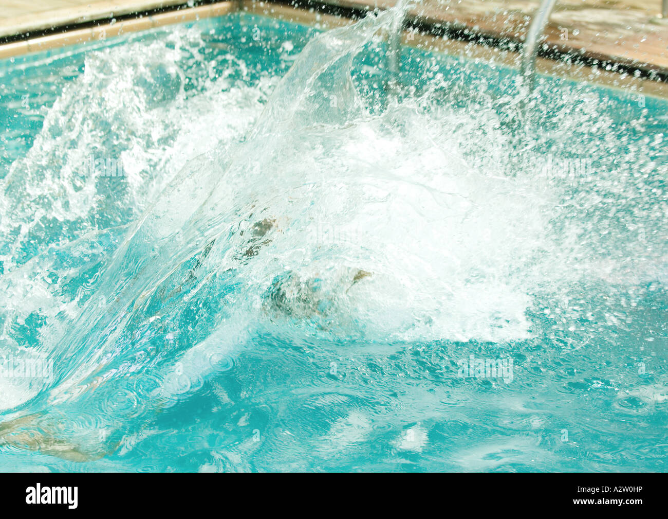 Water splashing as person jumps into pool Stock Photo - Alamy