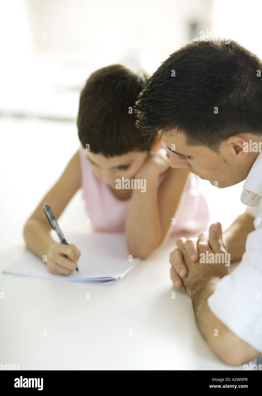 Father helping child with homework Stock Photo - Alamy