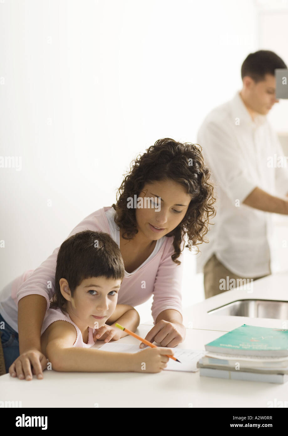 Mother helping child with homework Stock Photo - Alamy