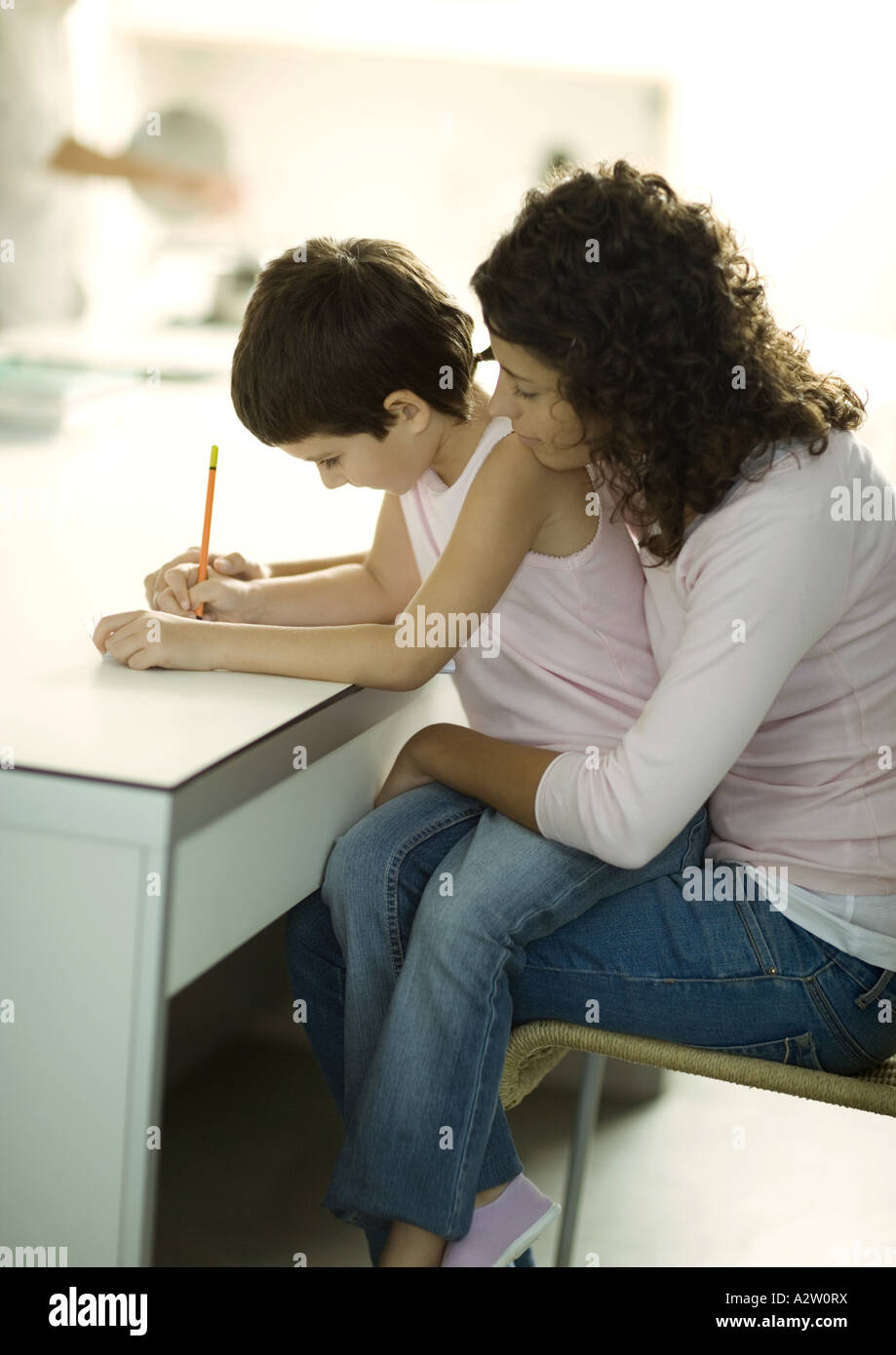 Mother helping child with homework Stock Photo - Alamy