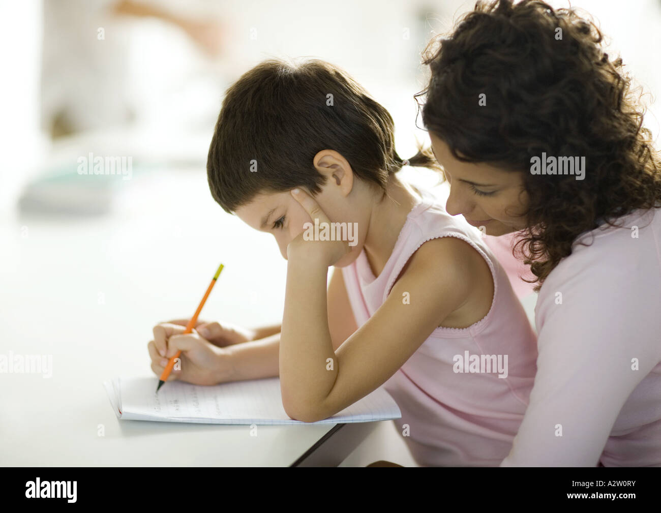 Mother helping child with homework Stock Photo - Alamy