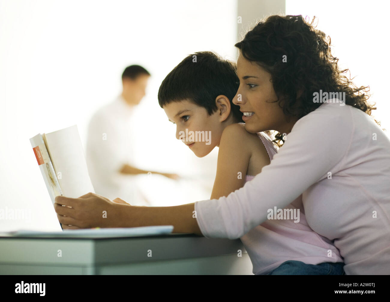 Mother helping child with homework Stock Photo - Alamy