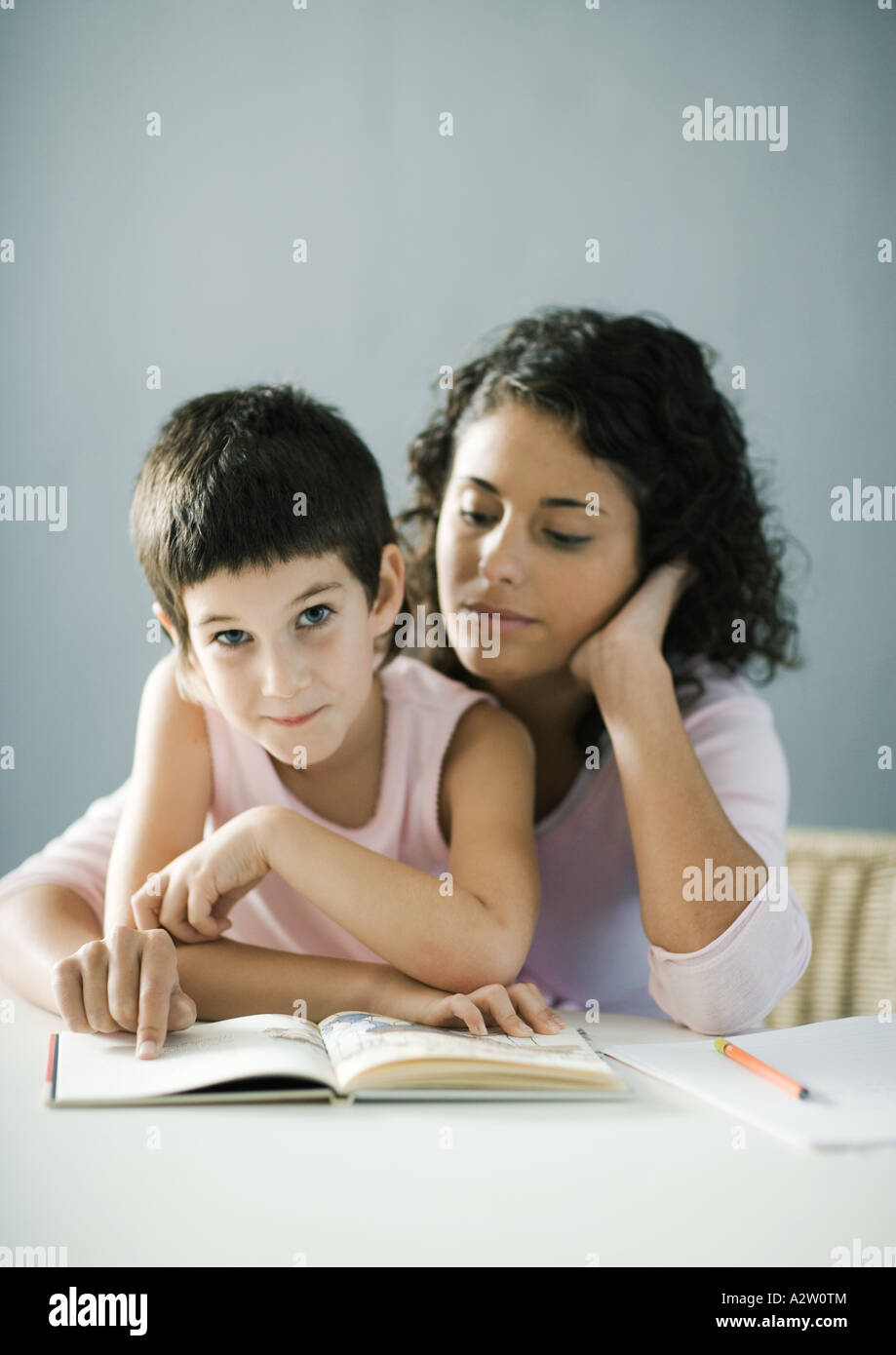 Mother helping child with homework Stock Photo - Alamy