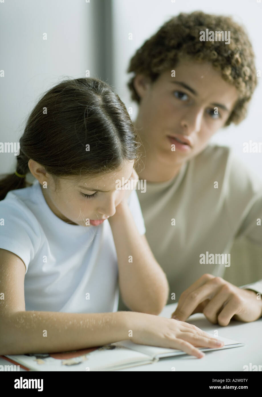 Older sister helping younger brother hi-res stock photography and ...