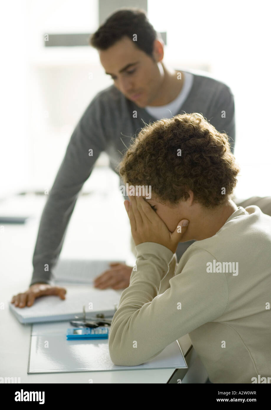 Man helping teenage son with homework Stock Photo - Alamy