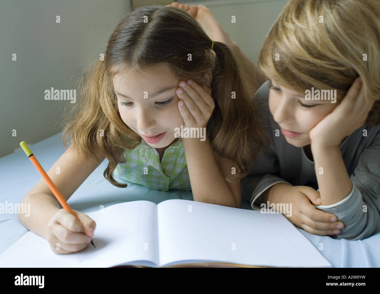 Two children doing homework together Stock Photo - Alamy