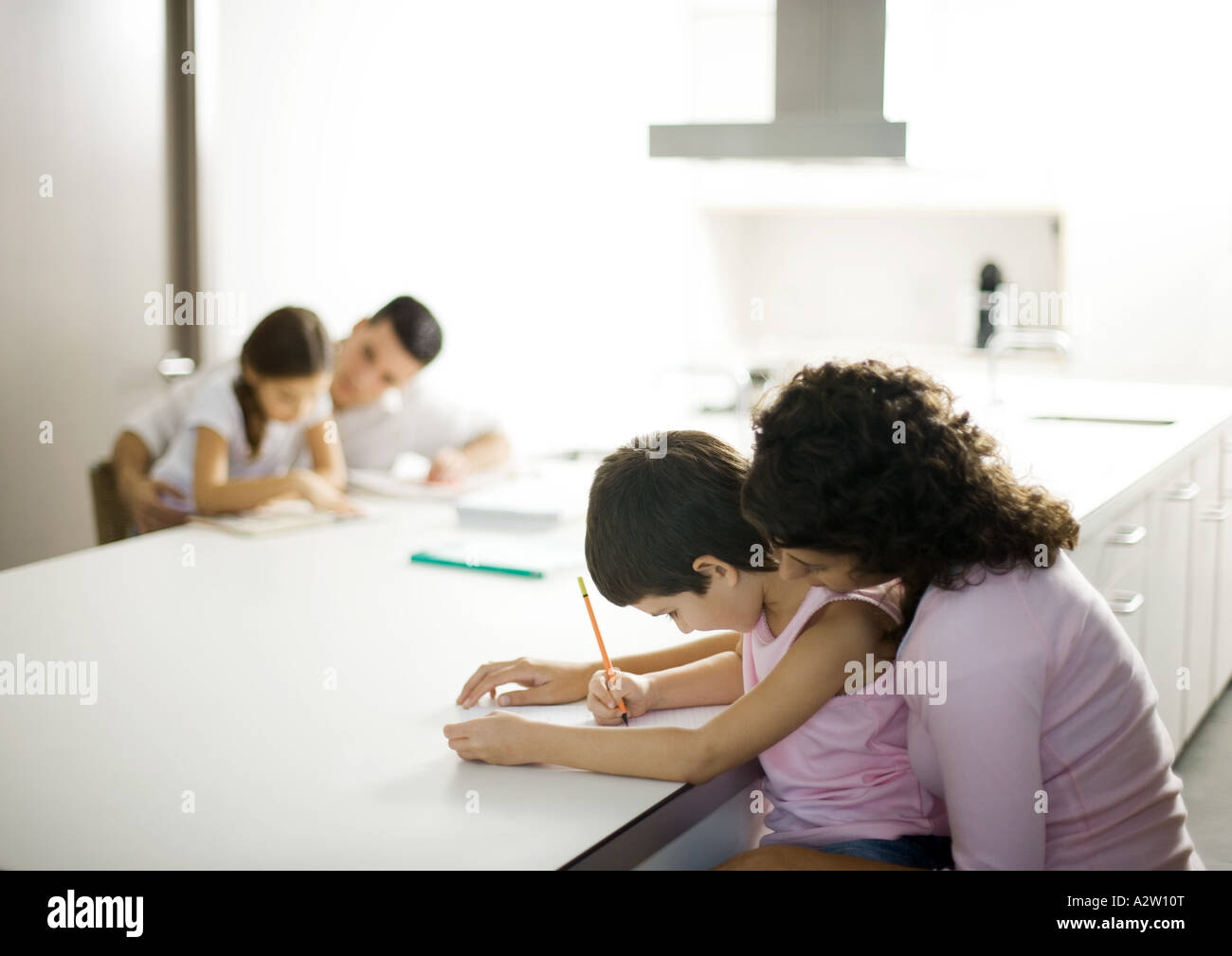 Parents helping their children with homework Stock Photo - Alamy