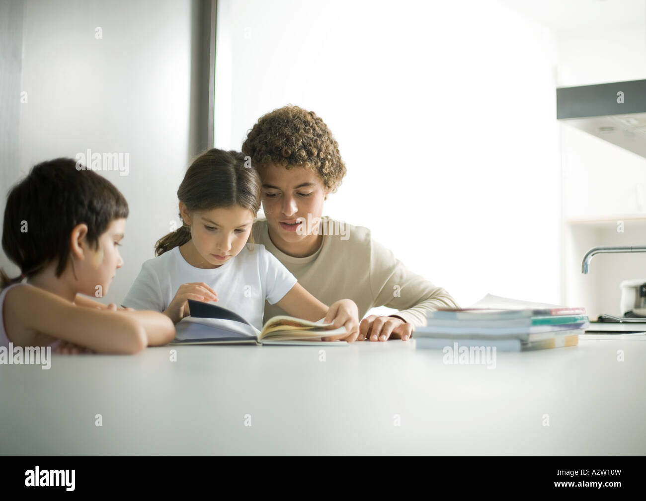 Teenager helping homework sister hi-res stock photography and images ...
