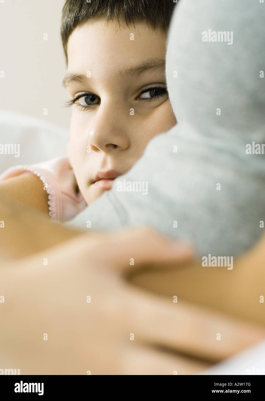 Child with arm around mother Stock Photo - Alamy