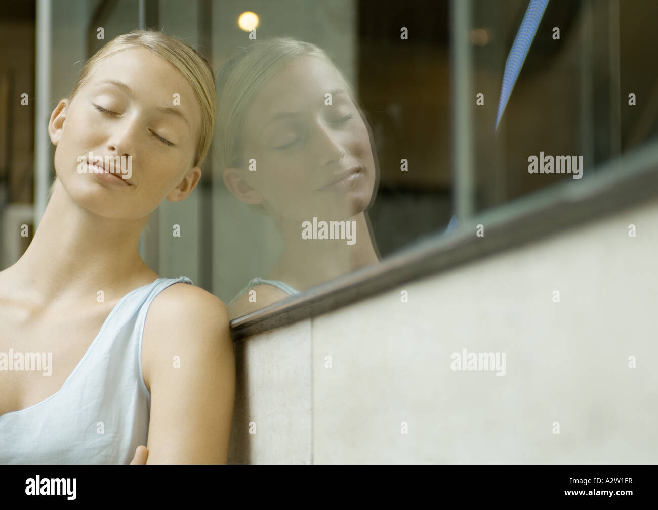 Woman resting head aganst window pane, eyes closed Stock Photo - Alamy