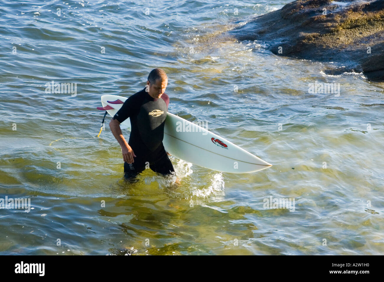 Serfer carrying a surfboard out of the beach Rio de Janeiro Brazil ...