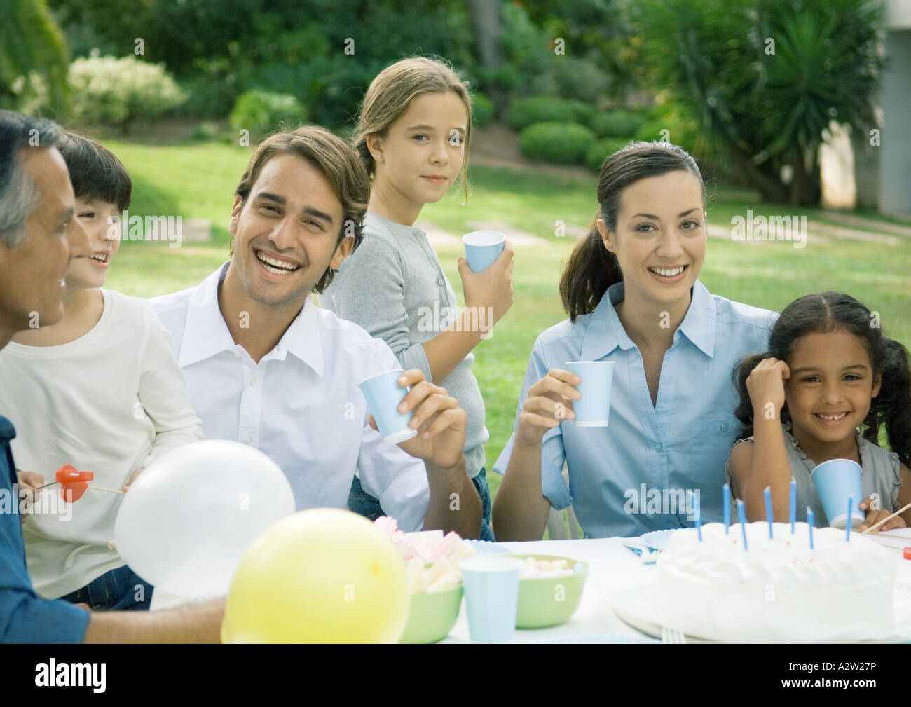 Outdoor birthday party attended by multi-generational family Stock ...