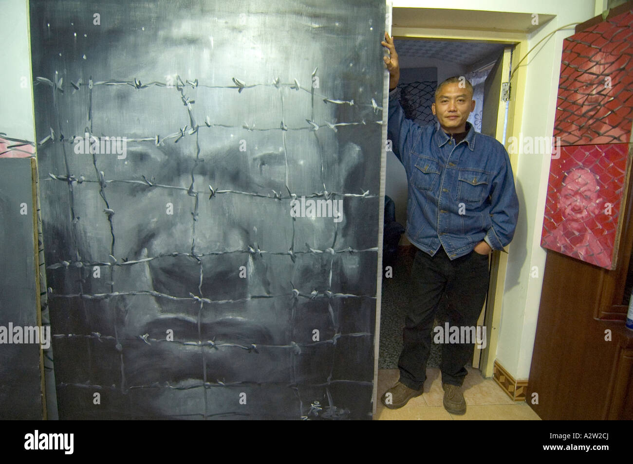 Portrait of a Chinese artist posing near one of his most striking work ...