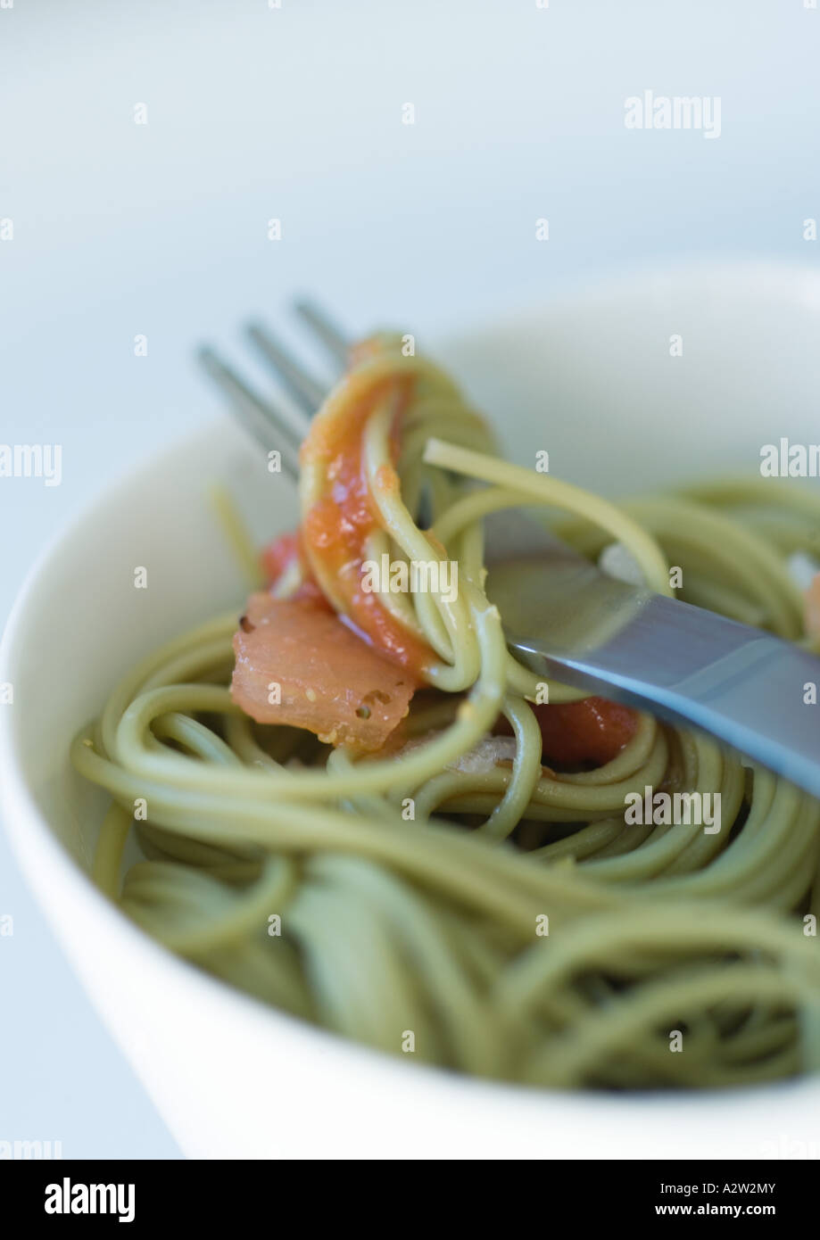 Fork inside bowl of pasta Stock Photo - Alamy