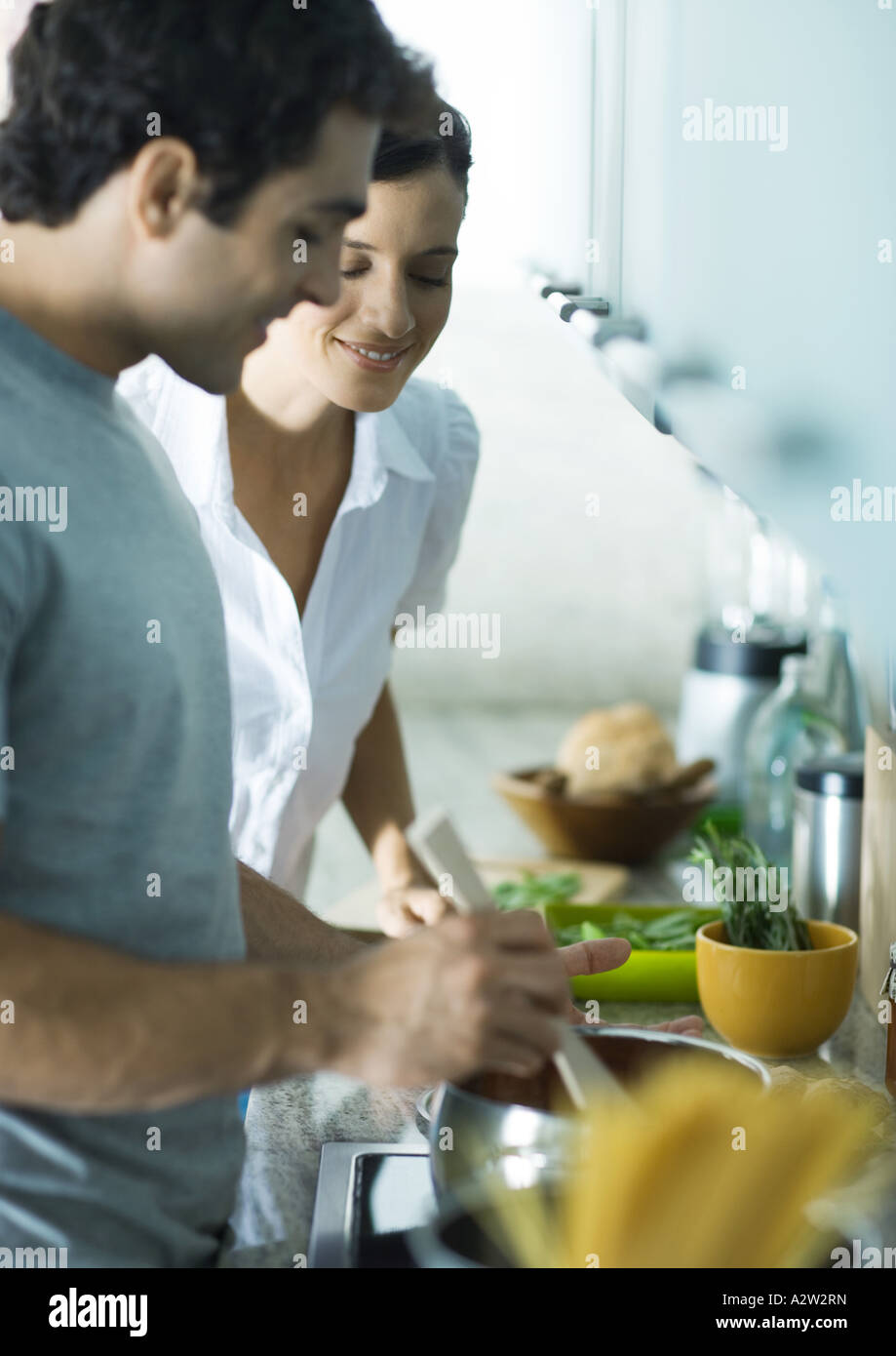Couple cooking in kitchen Stock Photo - Alamy
