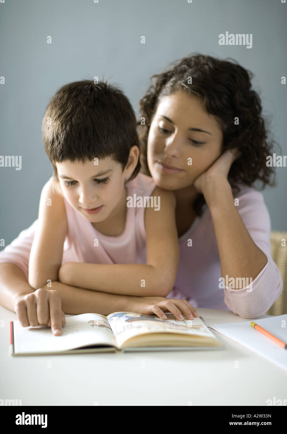 Mother and child reading book Stock Photo - Alamy