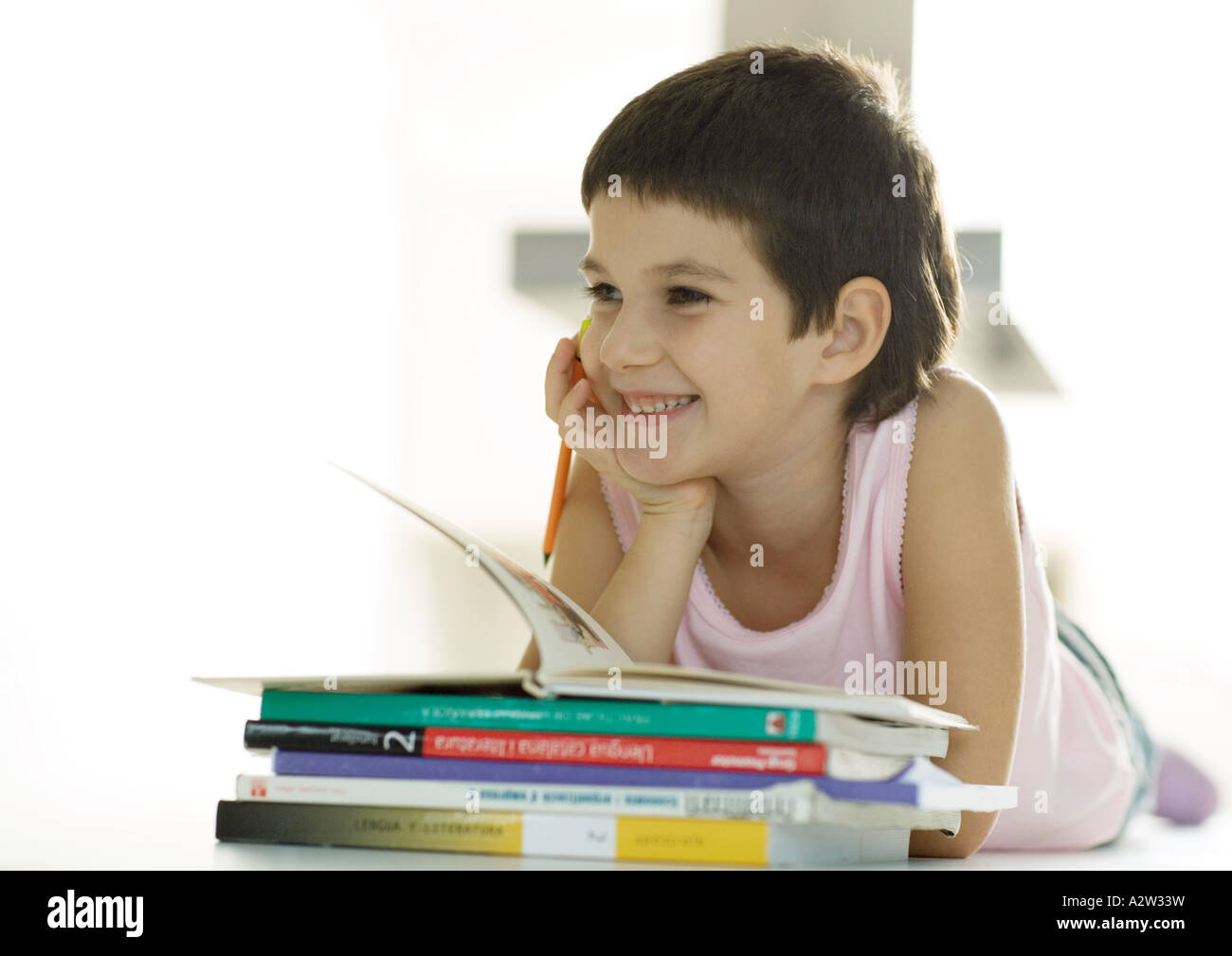 Child piles books hi-res stock photography and images - Alamy