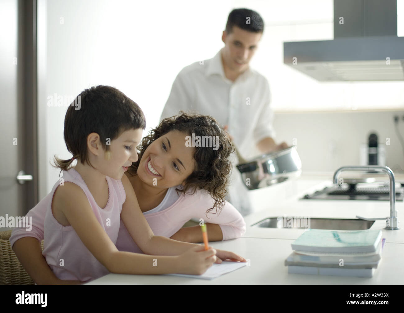Mother helping child with homework Stock Photo - Alamy