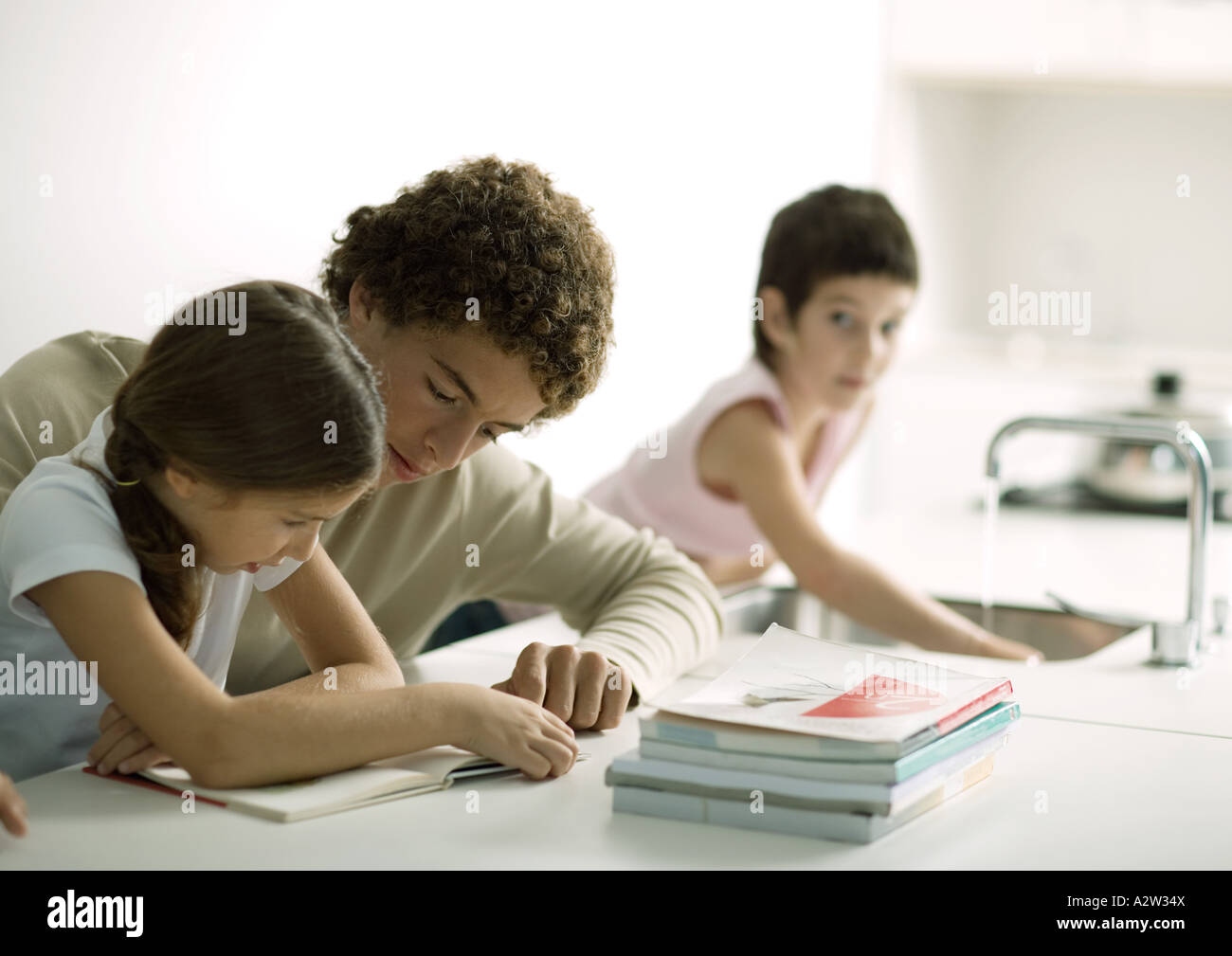 Older sister helping younger brother hi-res stock photography and ...