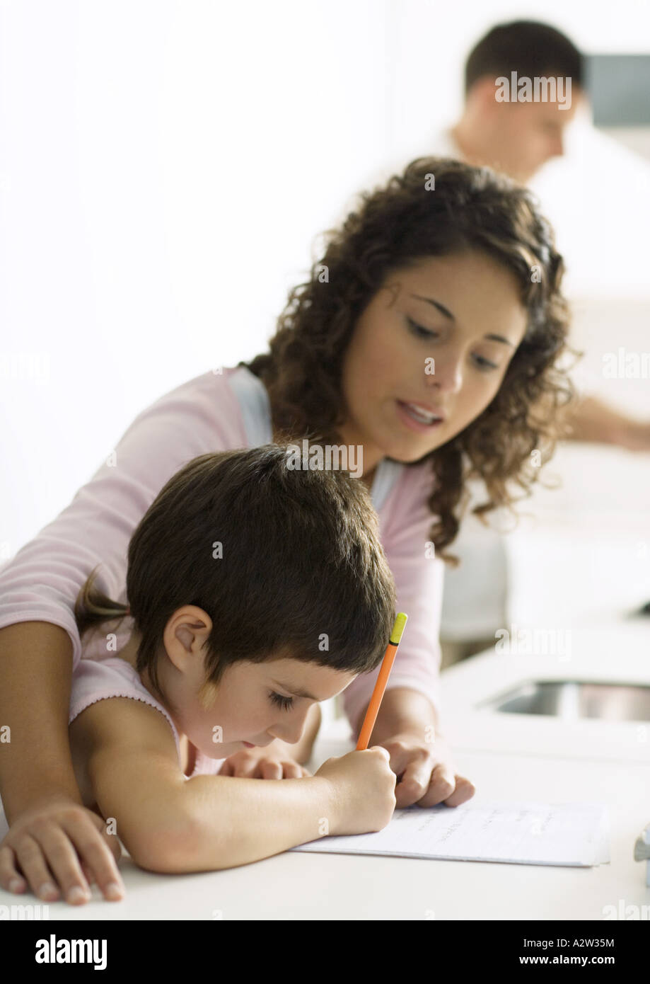 Mother helping child with homework Stock Photo - Alamy