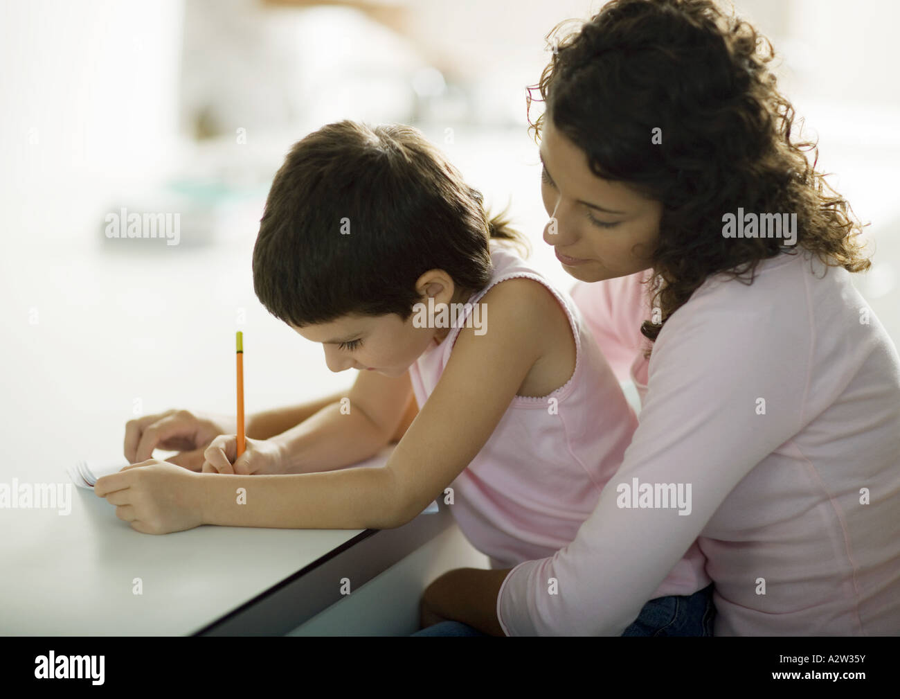 Mother helping child with homework Stock Photo - Alamy
