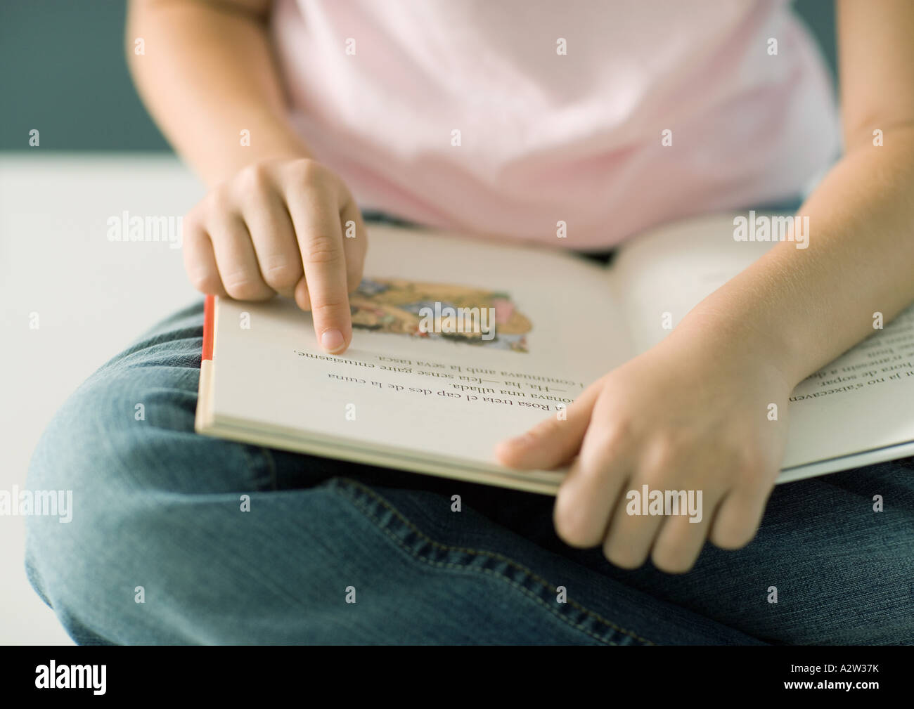 Child reading book, pointing to words, close-up Stock Photo - Alamy