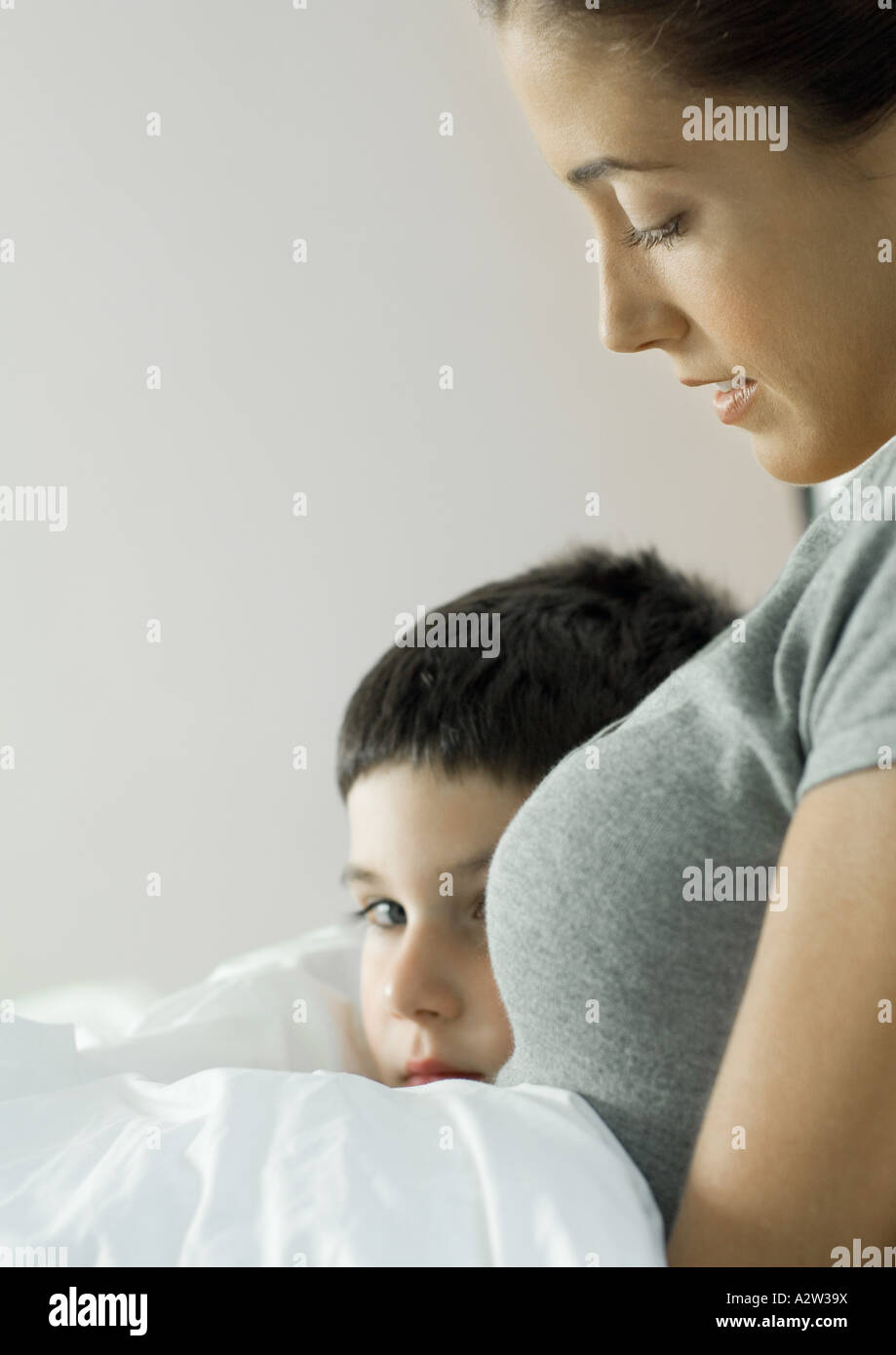 Child leaning against mother Stock Photo - Alamy