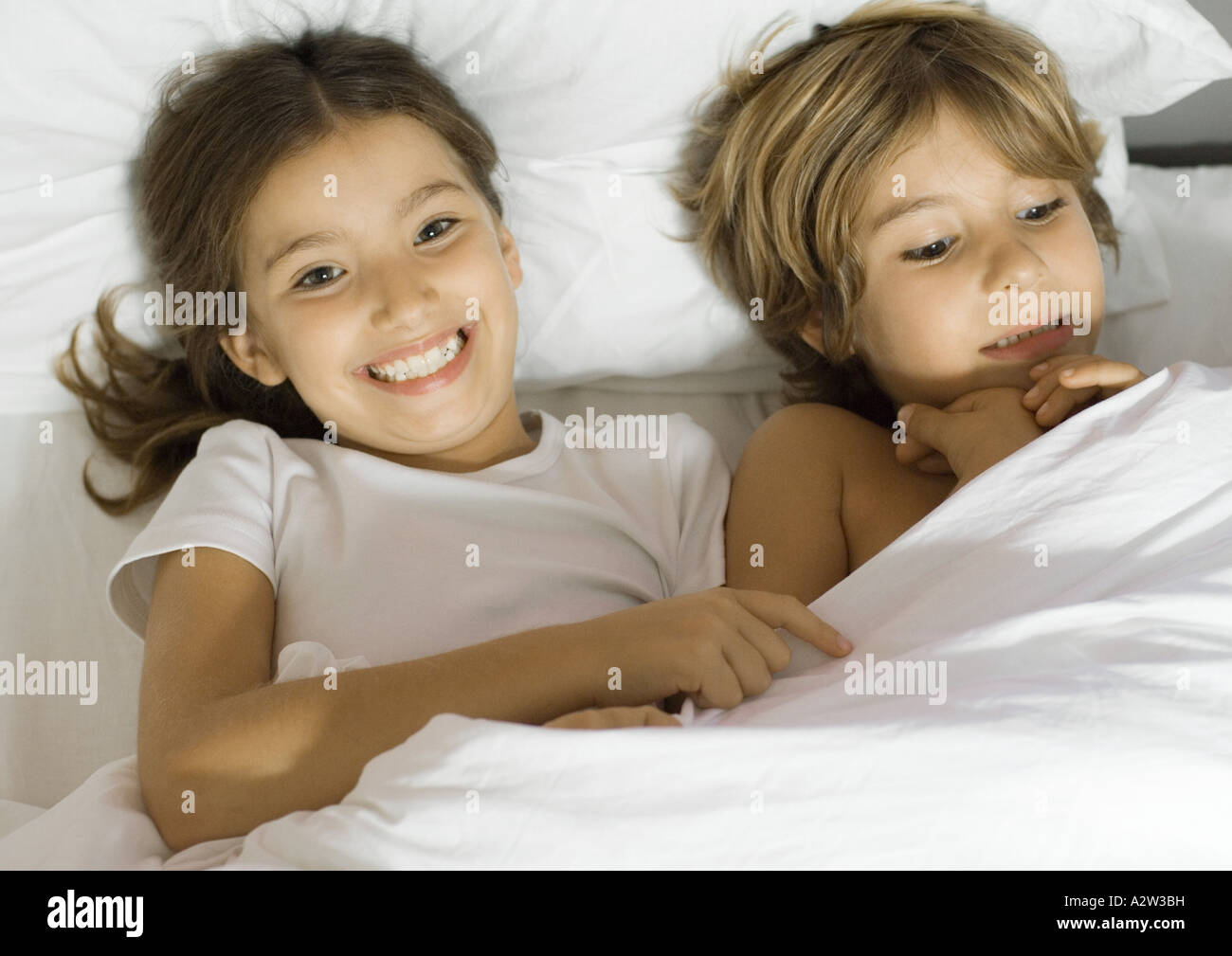 Brother and sister lying in bed together Stock Photo - Alamy
