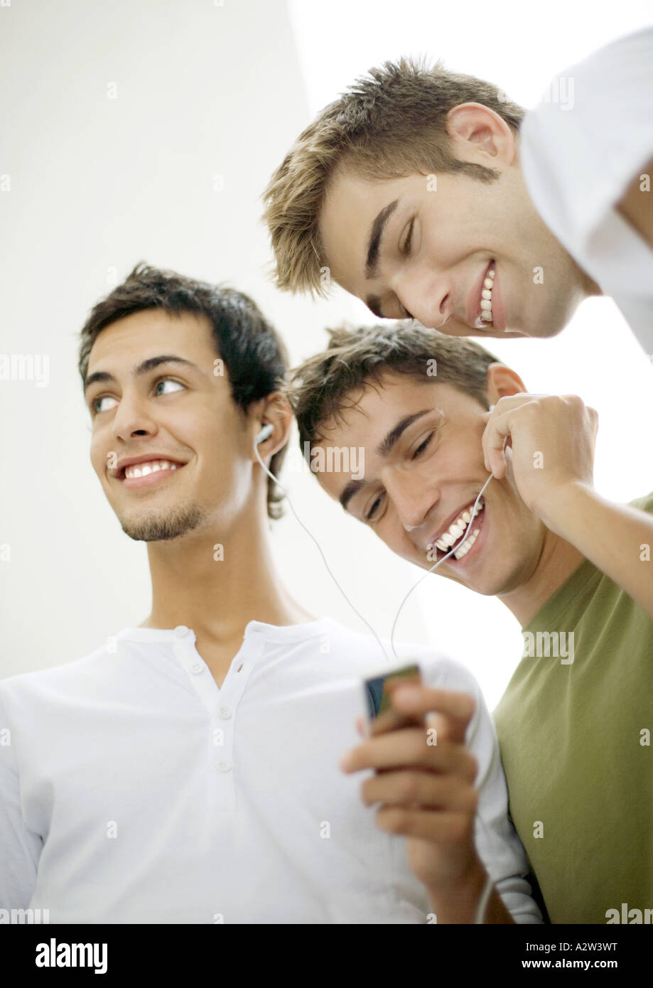 Teen males listening to MP3 player Stock Photo - Alamy