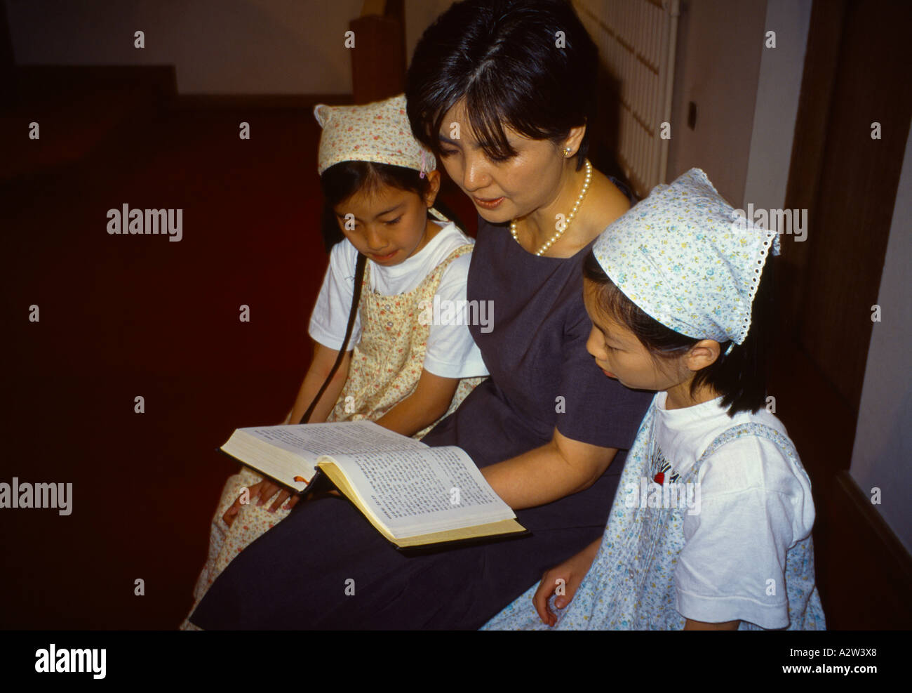 Korean Mother Reading Bible To Korean Children Stock Photo - Alamy