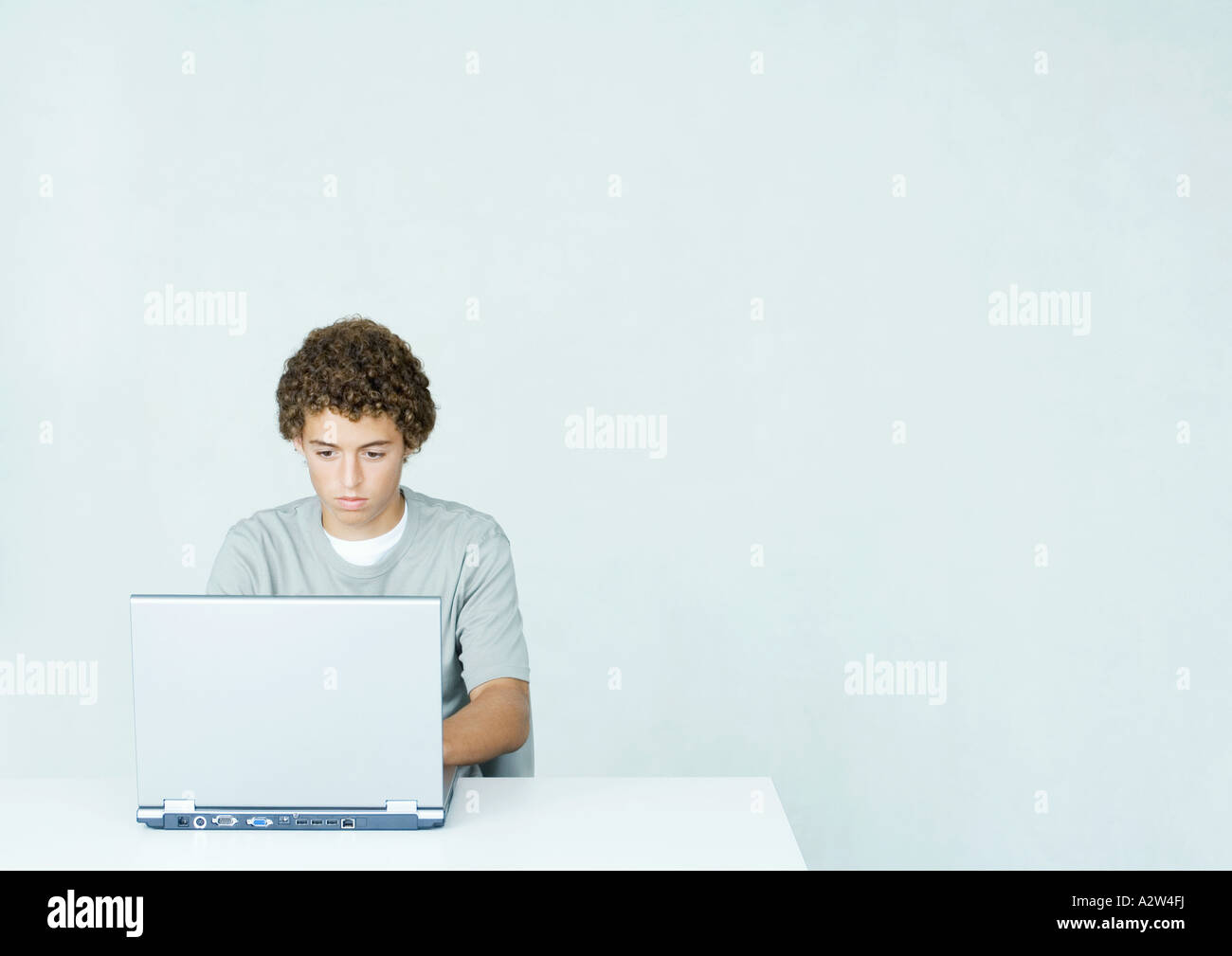 Young man using laptop, front view Stock Photo - Alamy