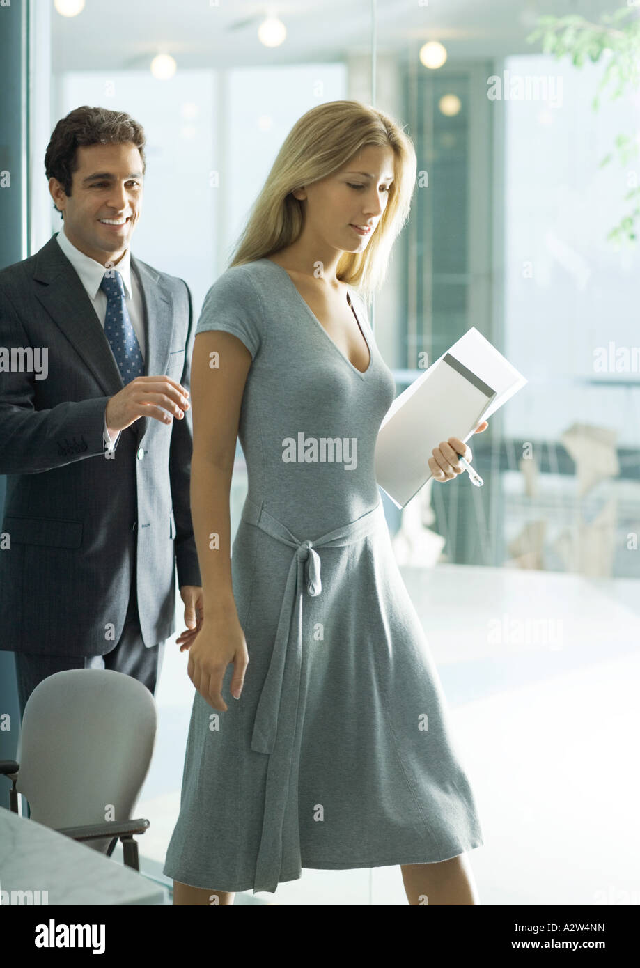 Professional man and woman stepping away from table Stock Photo - Alamy