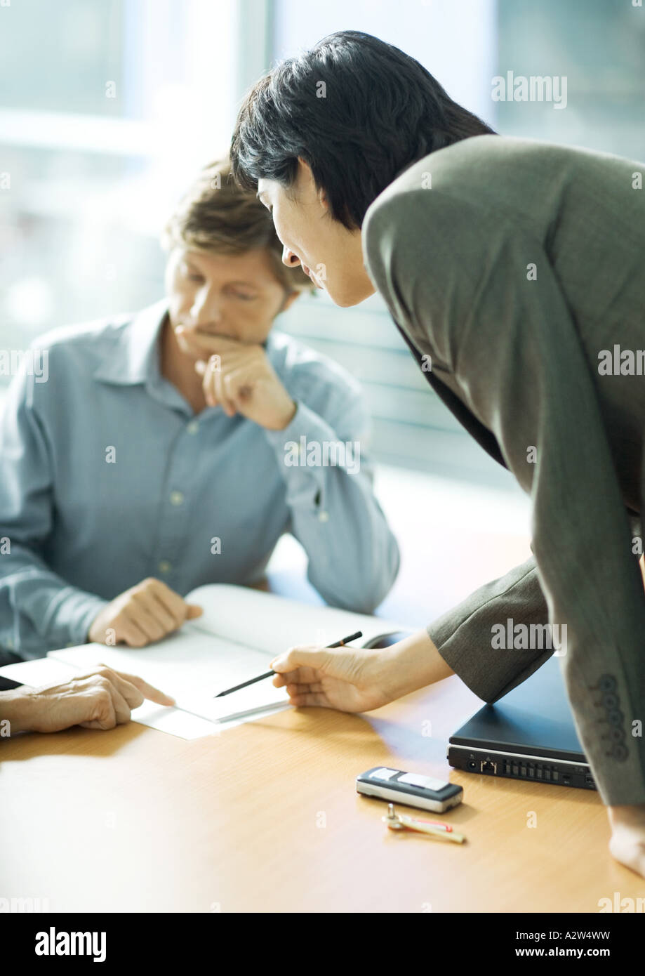 Businessman woman standing across table hi-res stock photography and ...