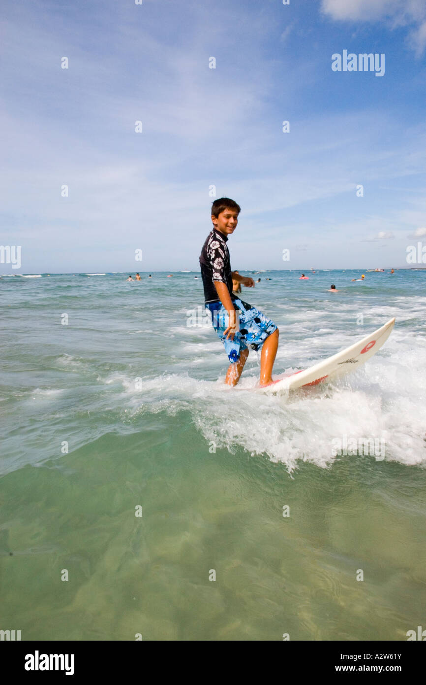 Boy on a surfboard, Waikiki Beach, Oahu Stock Photo - Alamy